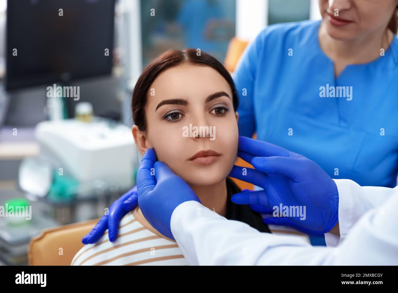 Professional doctors examining patient before surgery in clinic Stock ...