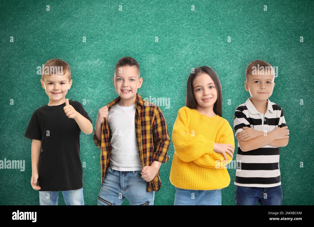Group of cute school children and chalkboard on background Stock Photo ...