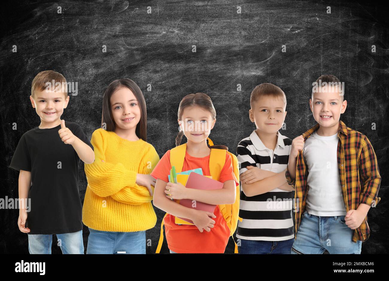 Group of cute school children and chalkboard on background Stock Photo ...