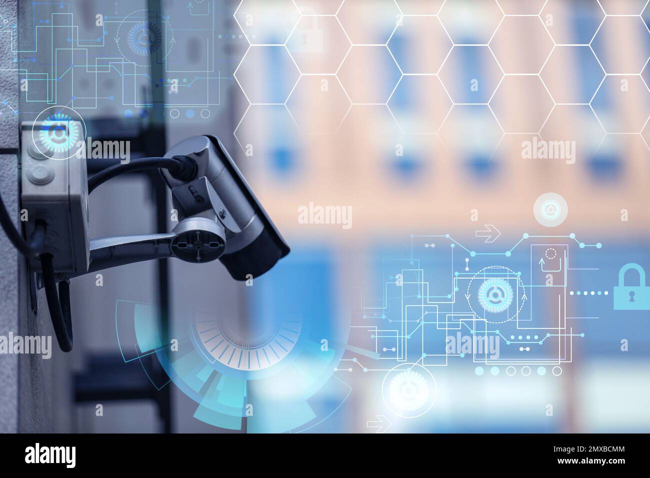 Modern CCTV security camera on building wall outdoors and digital ...