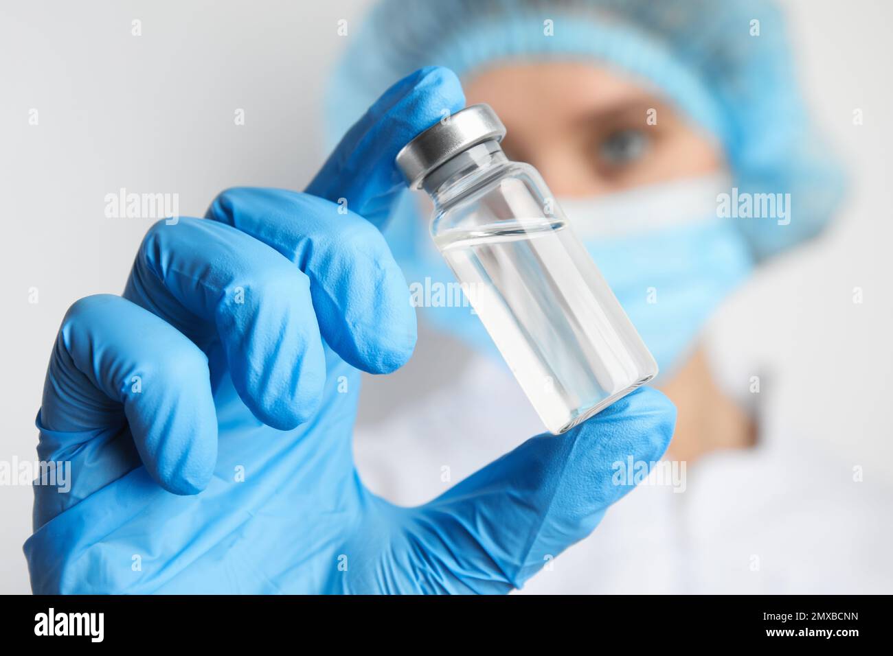 Doctor holding vial with medication, closeup. Vaccination and ...