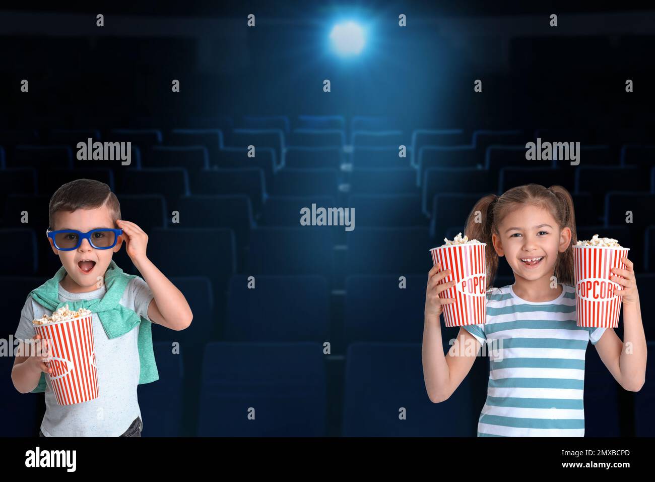 Cute little children with popcorn in cinema hall Stock Photo - Alamy