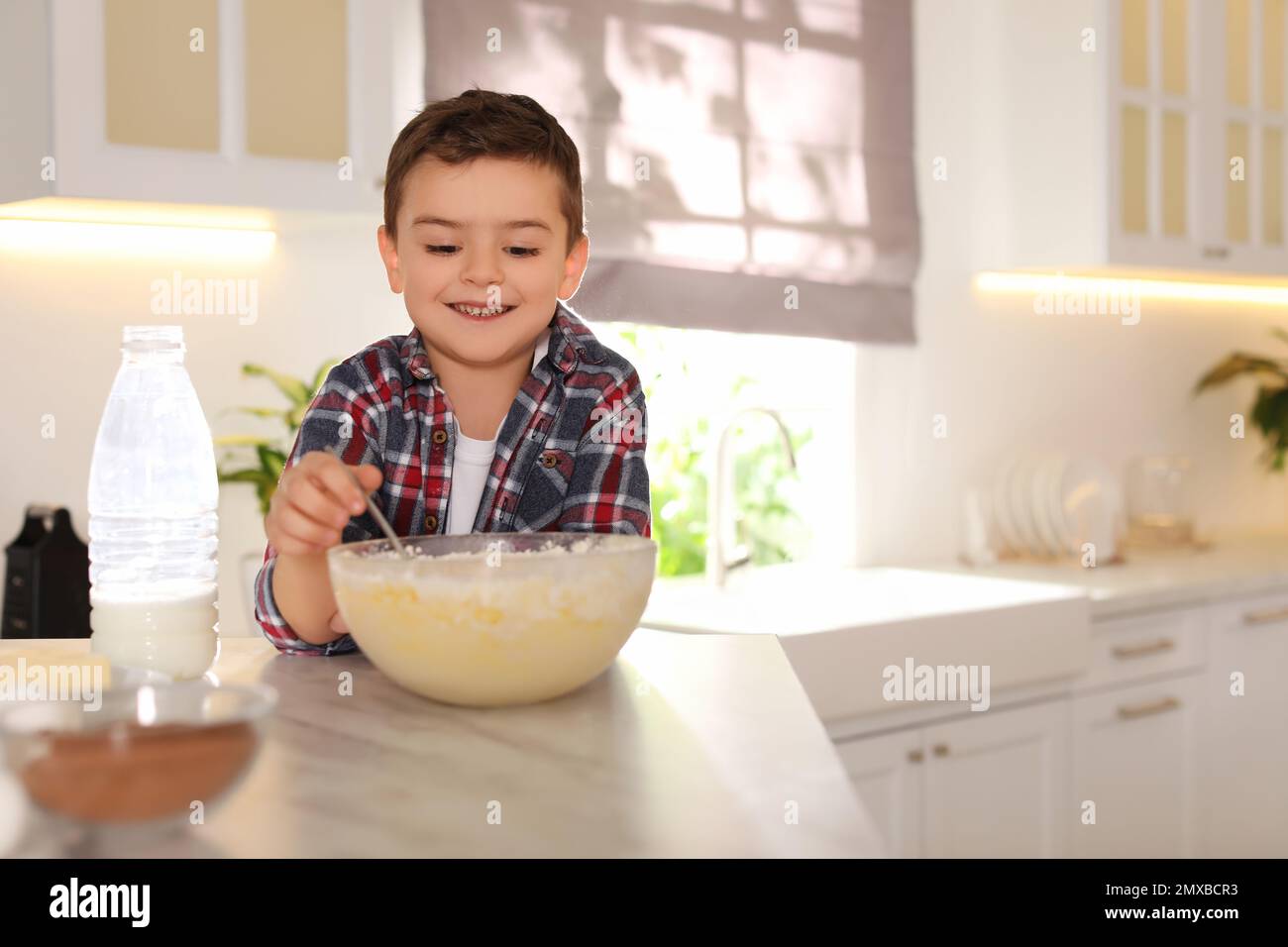 Cute little boy cooking dough in kitchen at home Stock Photo - Alamy