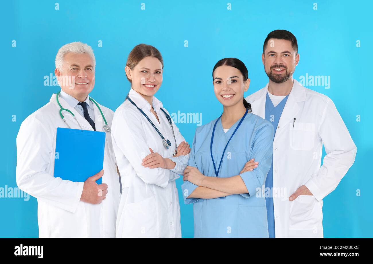 Group of doctors against blue background. Medical service Stock Photo ...