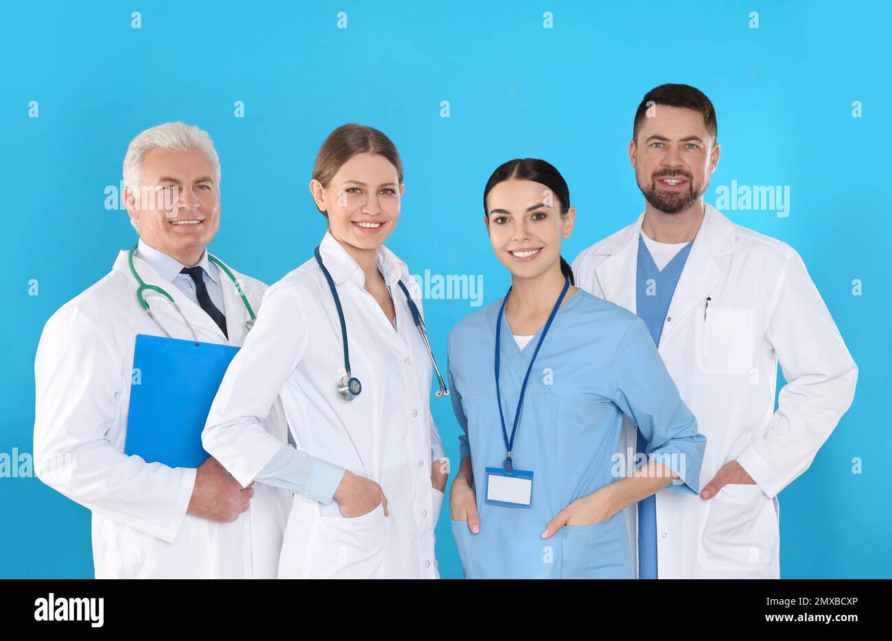 Group of doctors against blue background. Medical service Stock Photo ...