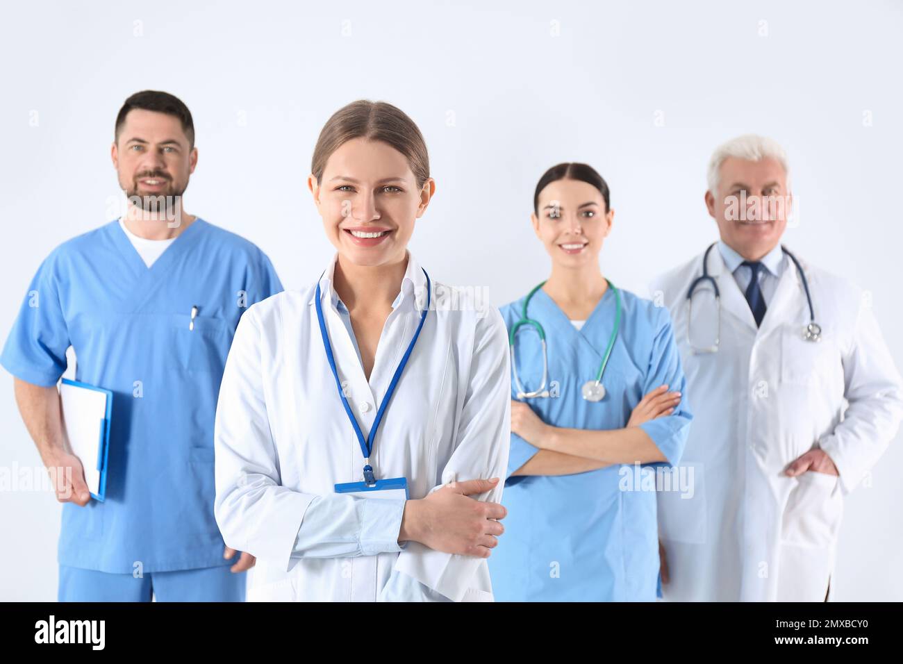 Group of doctors against light background. Medical service Stock Photo ...
