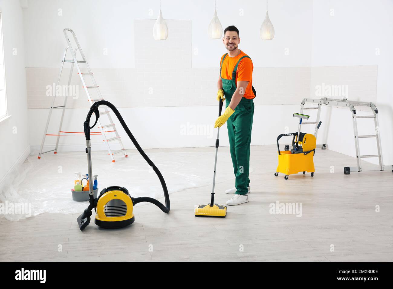 Professional janitor cleaning floor with mop after renovation Stock ...