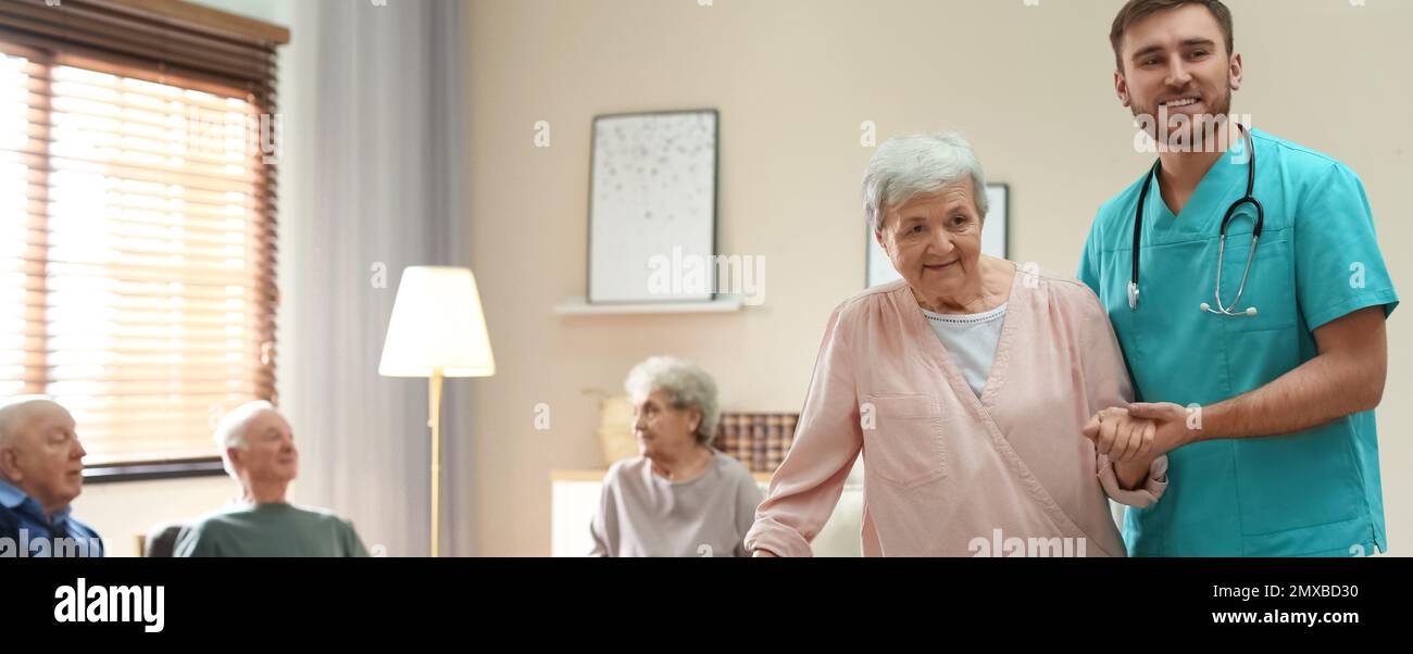Medical worker taking care of elderly woman in geriatric hospice, space ...