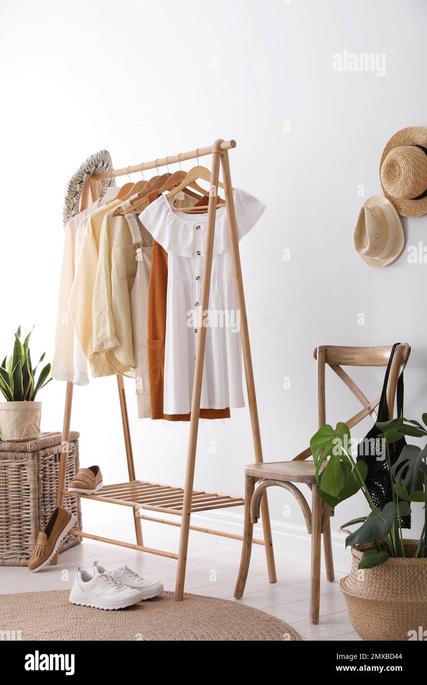 Rack with stylish women's clothes indoors. Interior design Stock Photo ...