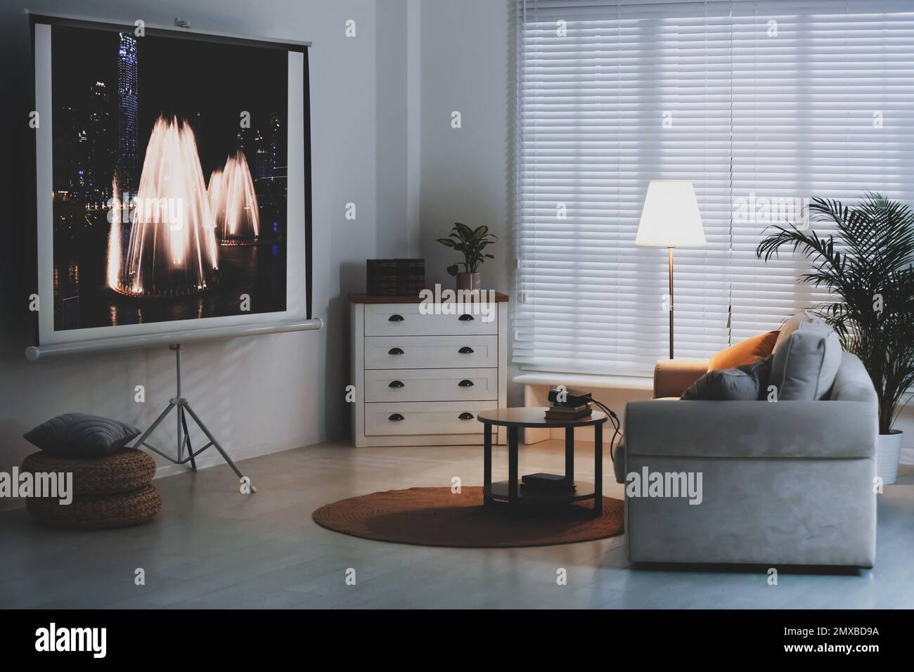 Stylish room with modern video projector and comfortable sofa Stock ...