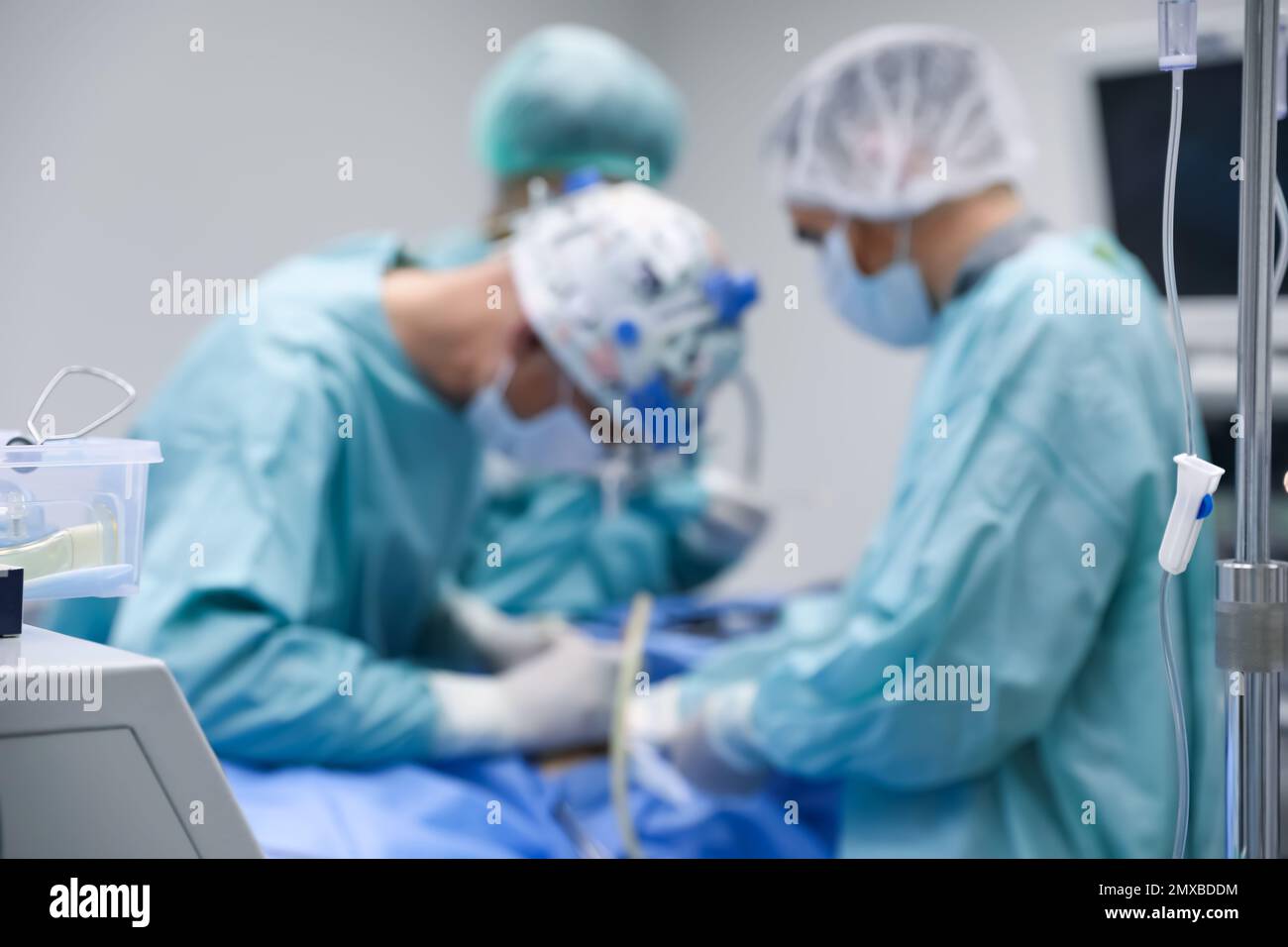 Blurred view of doctors operating patient in surgery room Stock Photo ...