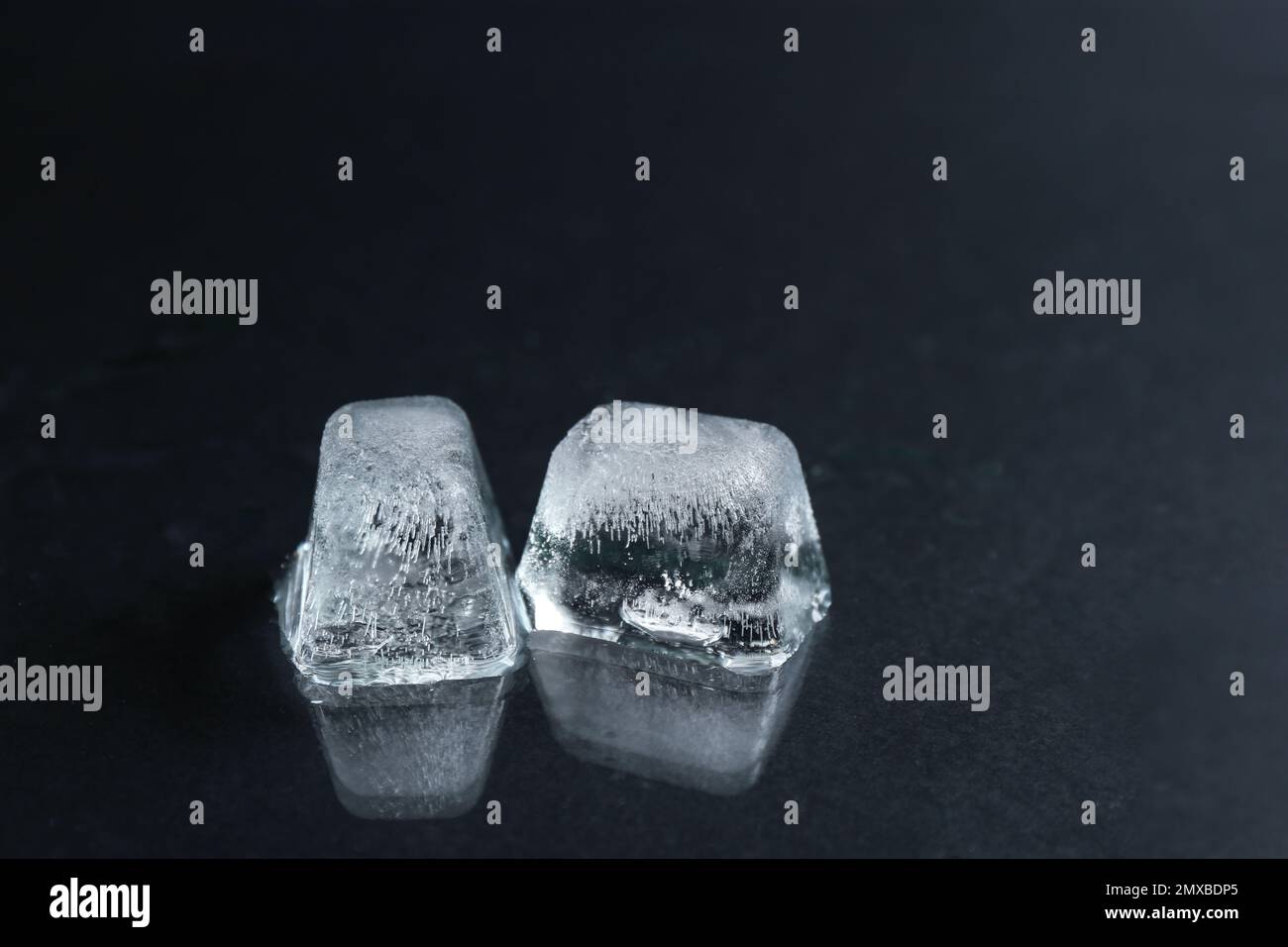 Ice cubes on wet black surface, closeup Stock Photo - Alamy
