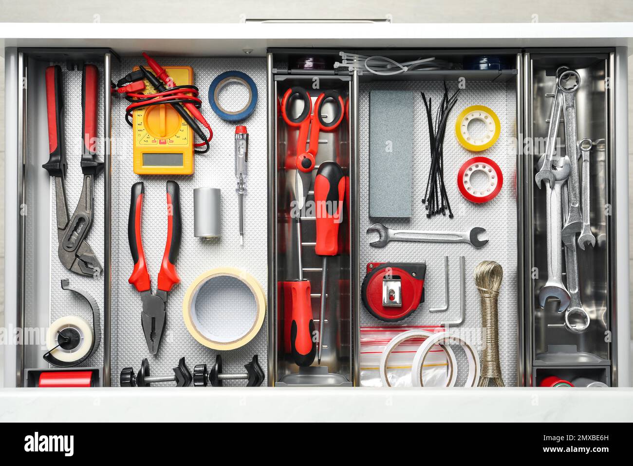 Set of instruments in open desk drawer, top view Stock Photo - Alamy