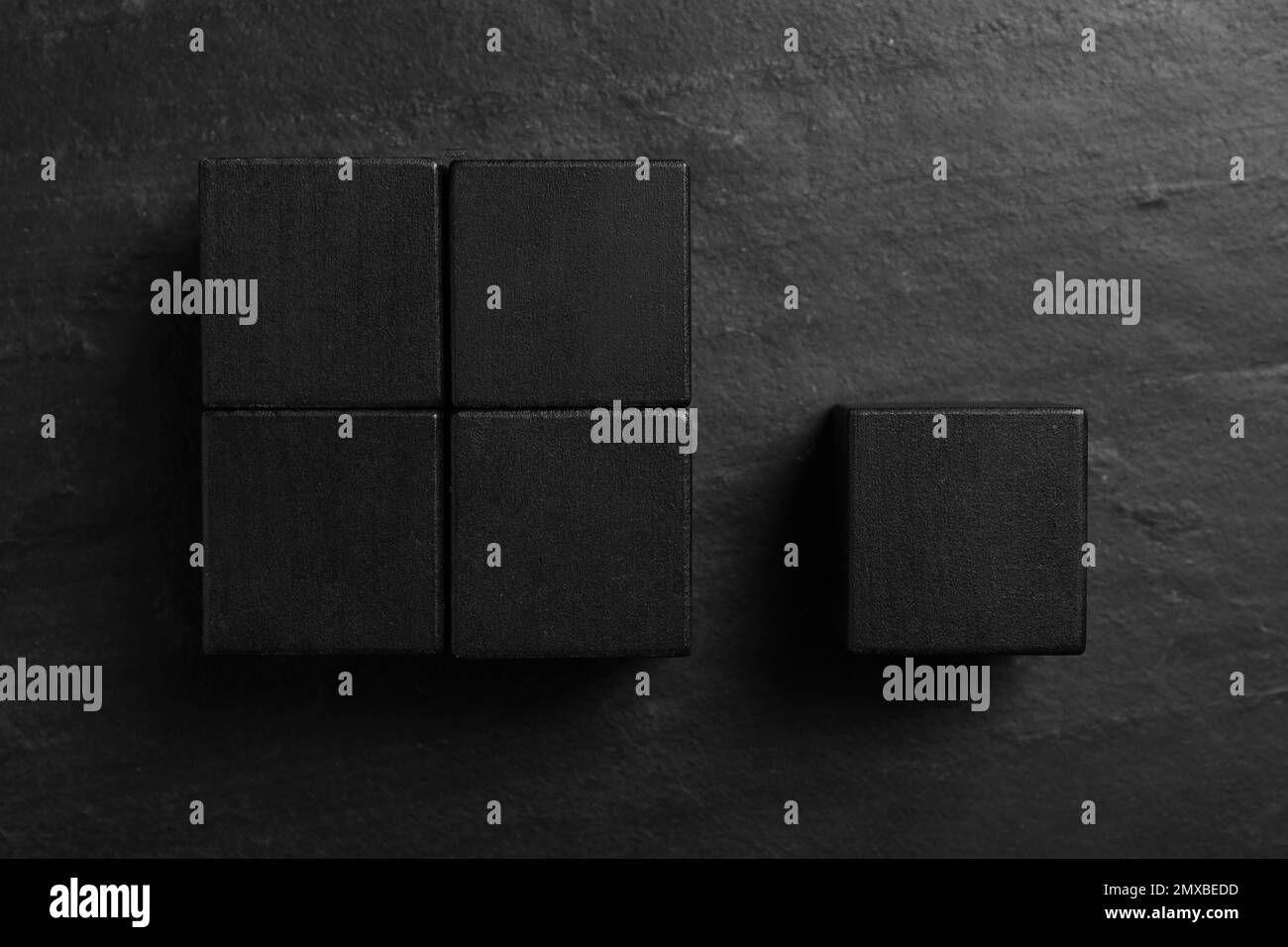 Flat lay composition with cubes on black slate background. Pareto ...