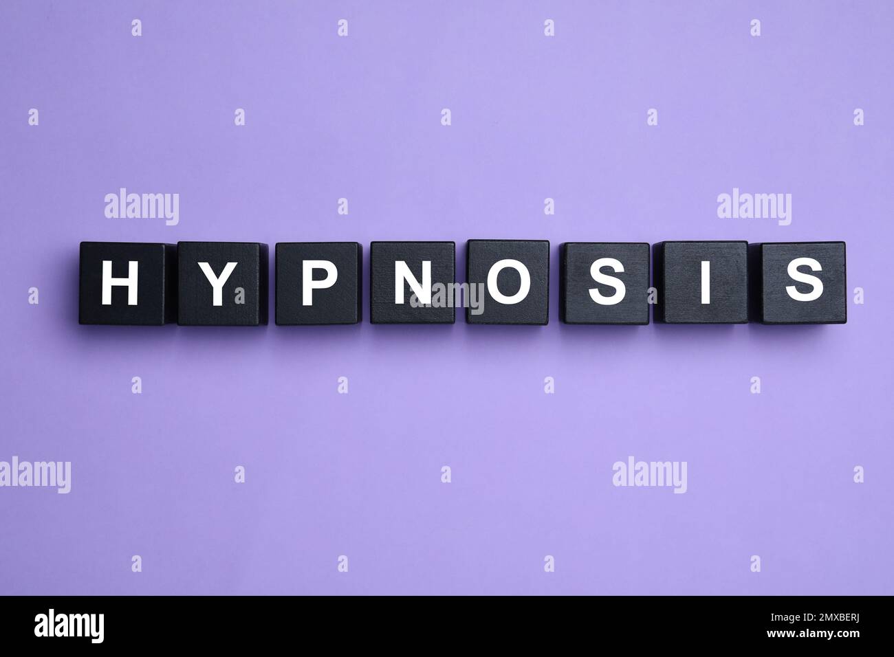 Black wooden blocks with word HYPNOSIS on violet background, flat lay ...