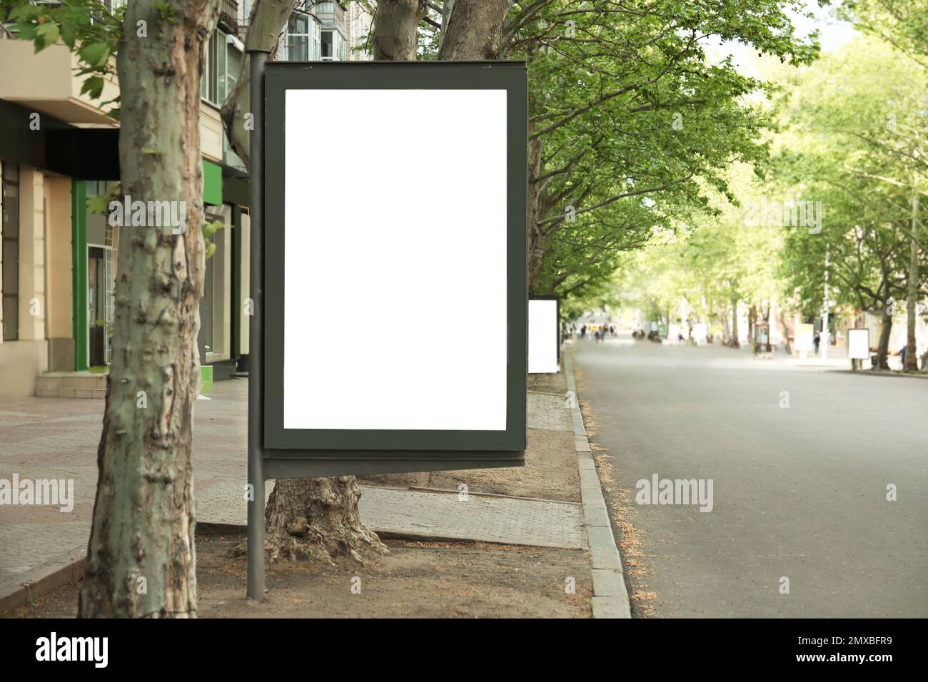 Blank advertising board on city street. Space for design Stock Photo ...
