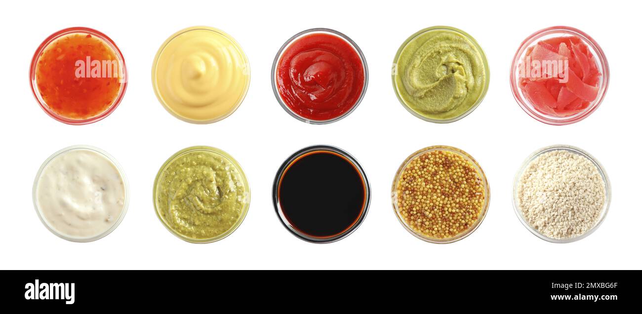 Set of different delicious sauces and condiments on white background ...