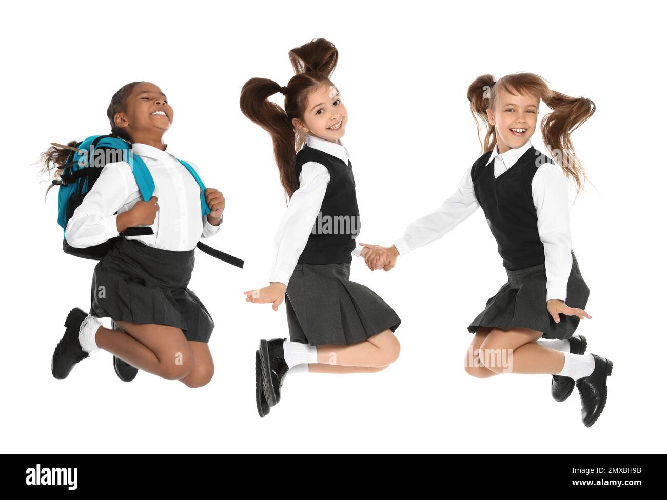 Children in school uniform jumping on white background Stock Photo - Alamy