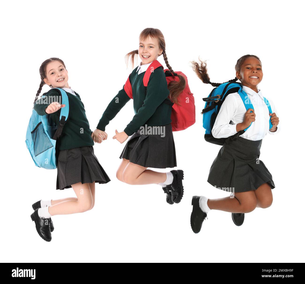 Children in school uniform jumping on white background Stock Photo - Alamy