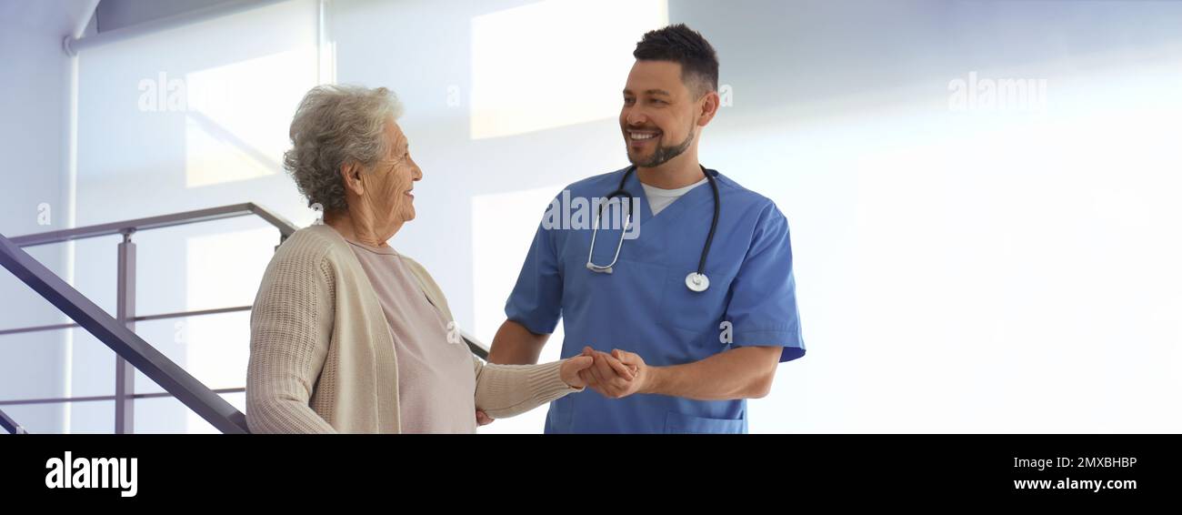 Doctor helping senior patient in modern hospital. Banner design Stock ...