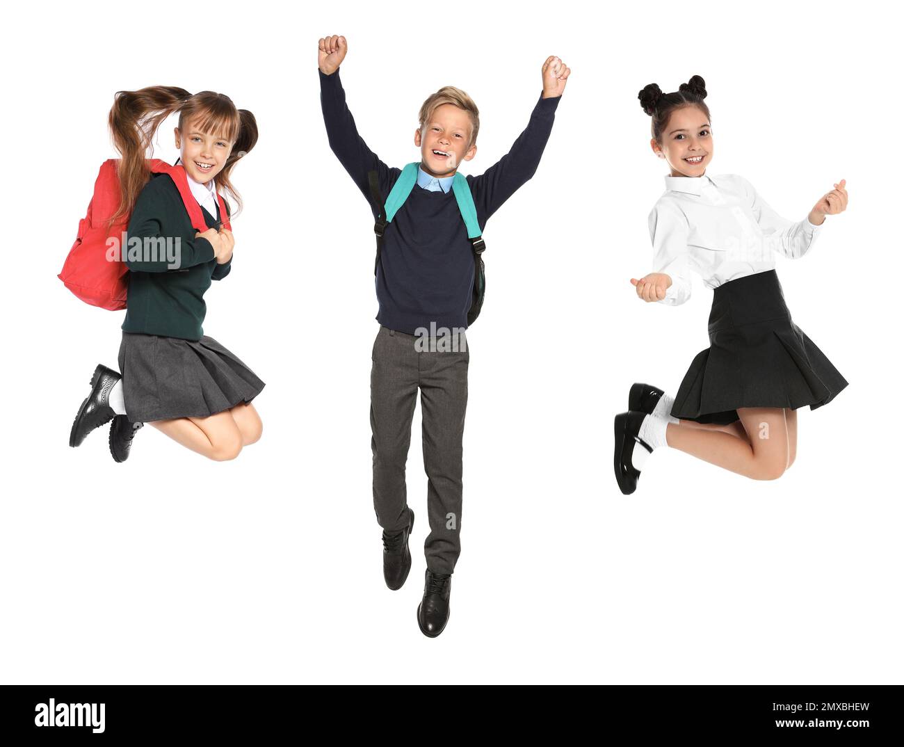 Children in school uniform jumping on white background Stock Photo - Alamy