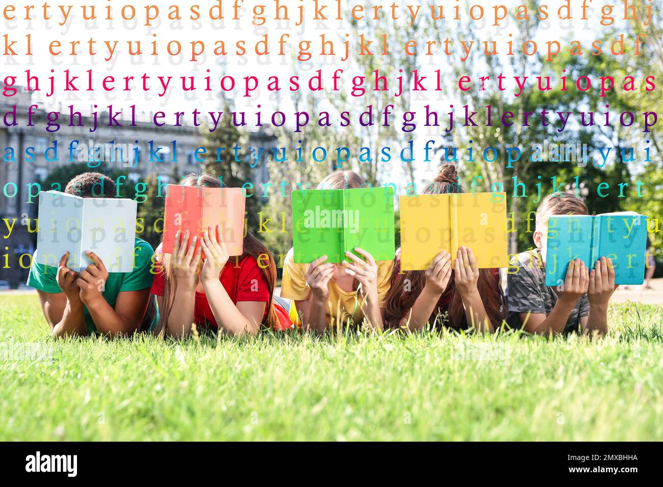 Group of little children reading books on green grass in park Stock ...