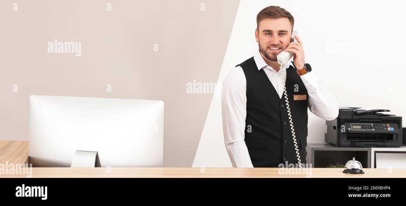 Receptionist talking on telephone at desk in modern hotel. Banner ...