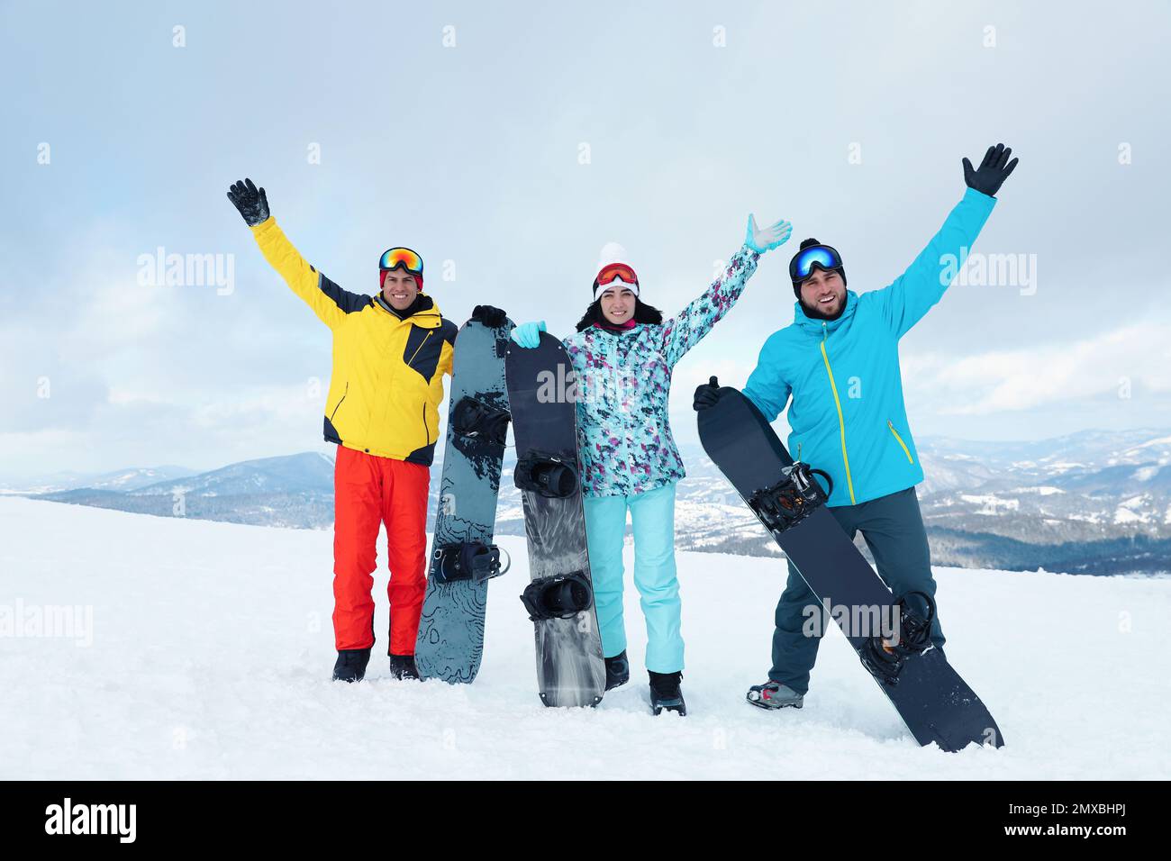 Group of friends with equipment in snowy mountains. Winter vacation ...