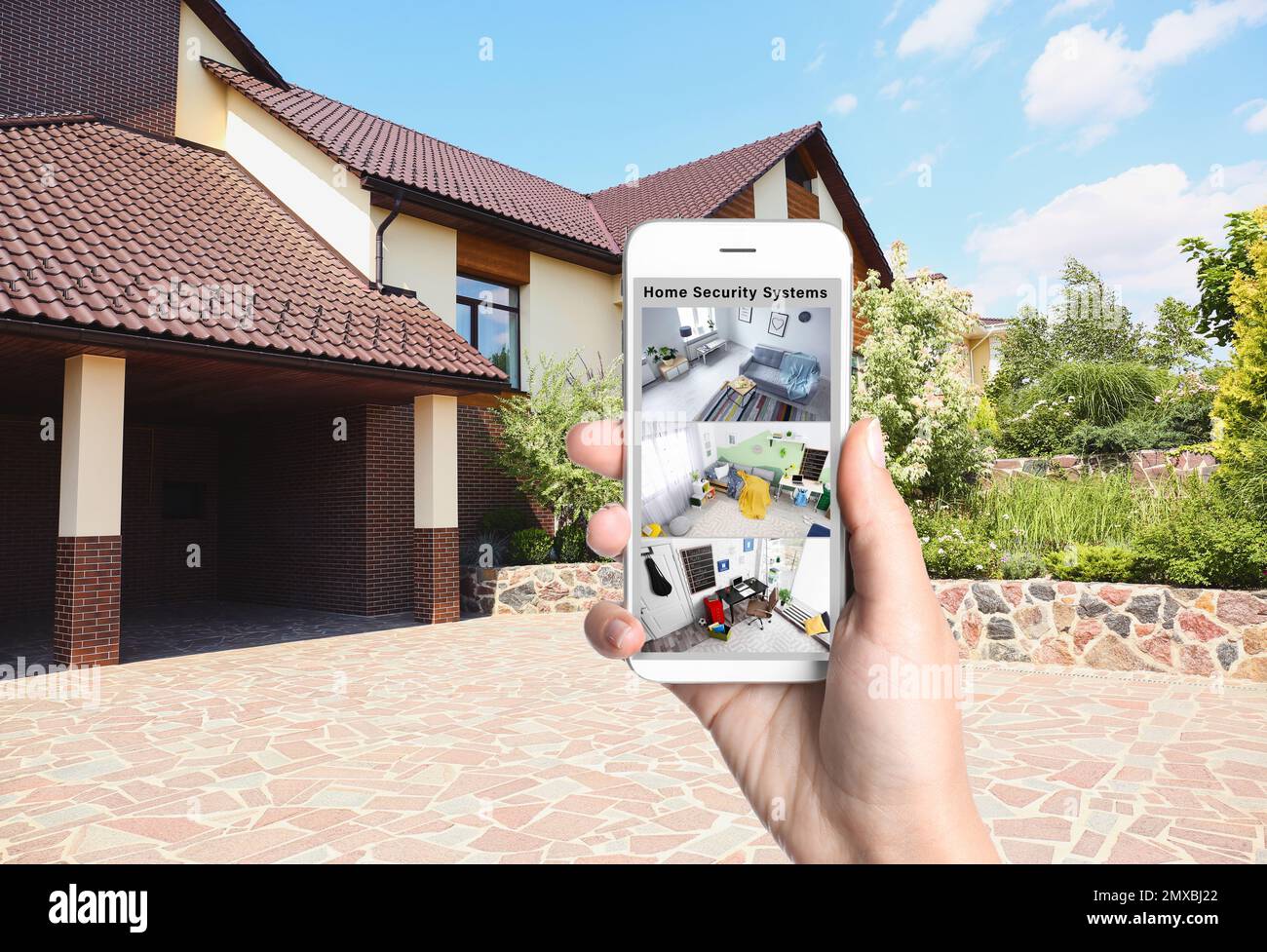 Alarm system. Woman monitoring modern CCTV cameras on smartphone near ...