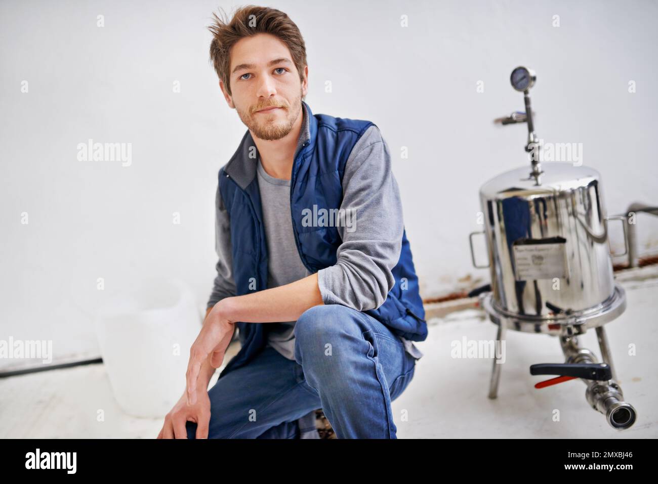 On the production line. Portrait of a happy young man working in a ...