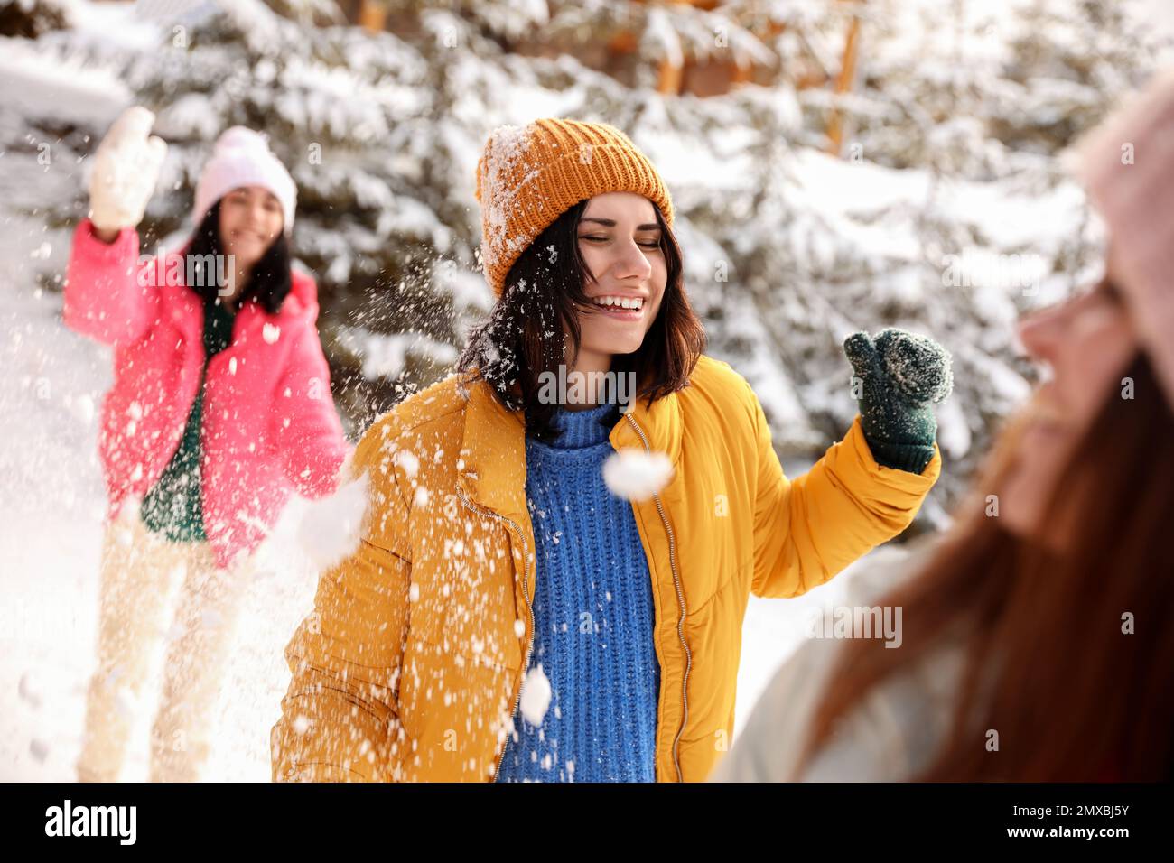 Group of friends playing snowballs outdoors. Winter vacation Stock ...