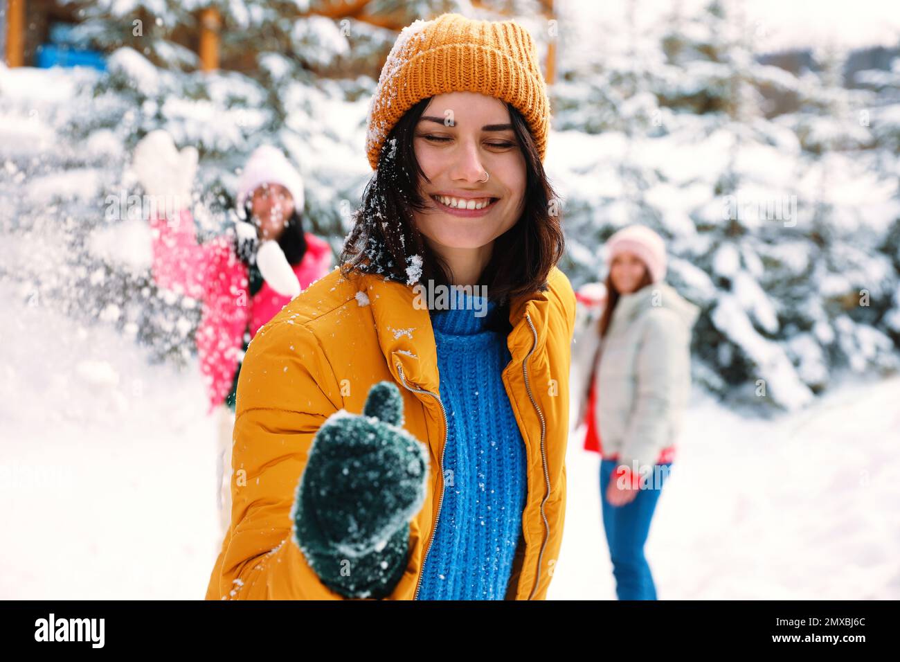 Group of friends playing snowballs outdoors. Winter vacation Stock ...