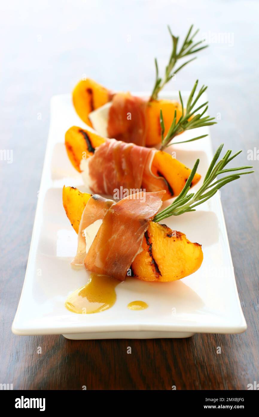 appetizer with grilled peach, ham and goat cheese Stock Photo - Alamy