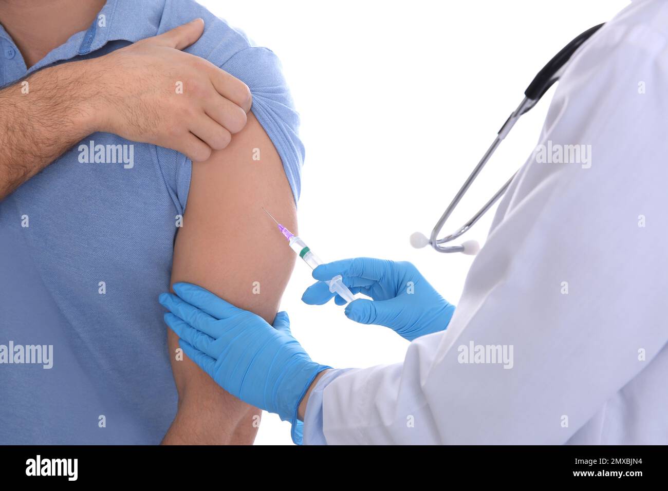 Doctor giving injection to patient on white background, closeup ...