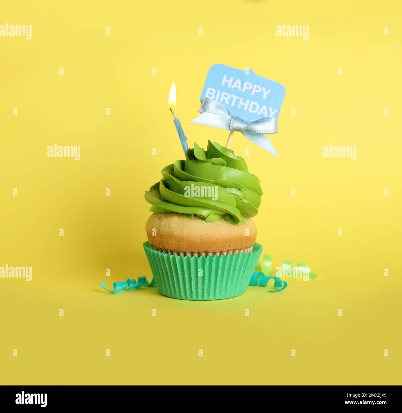 Beautiful birthday cupcake and streamers on yellow background Stock ...