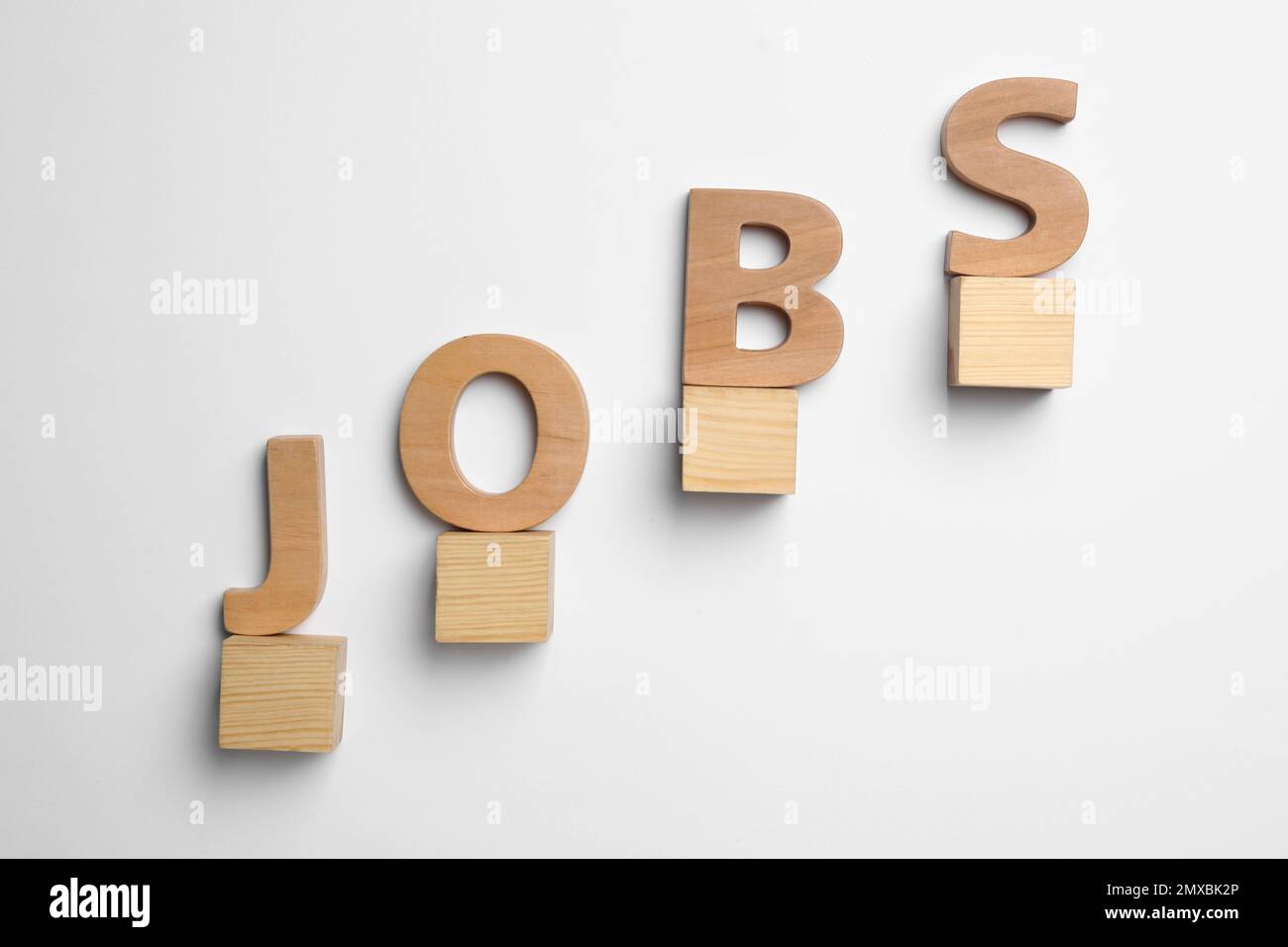 Word JOBS and wooden cubes on white background, top view. Career ...