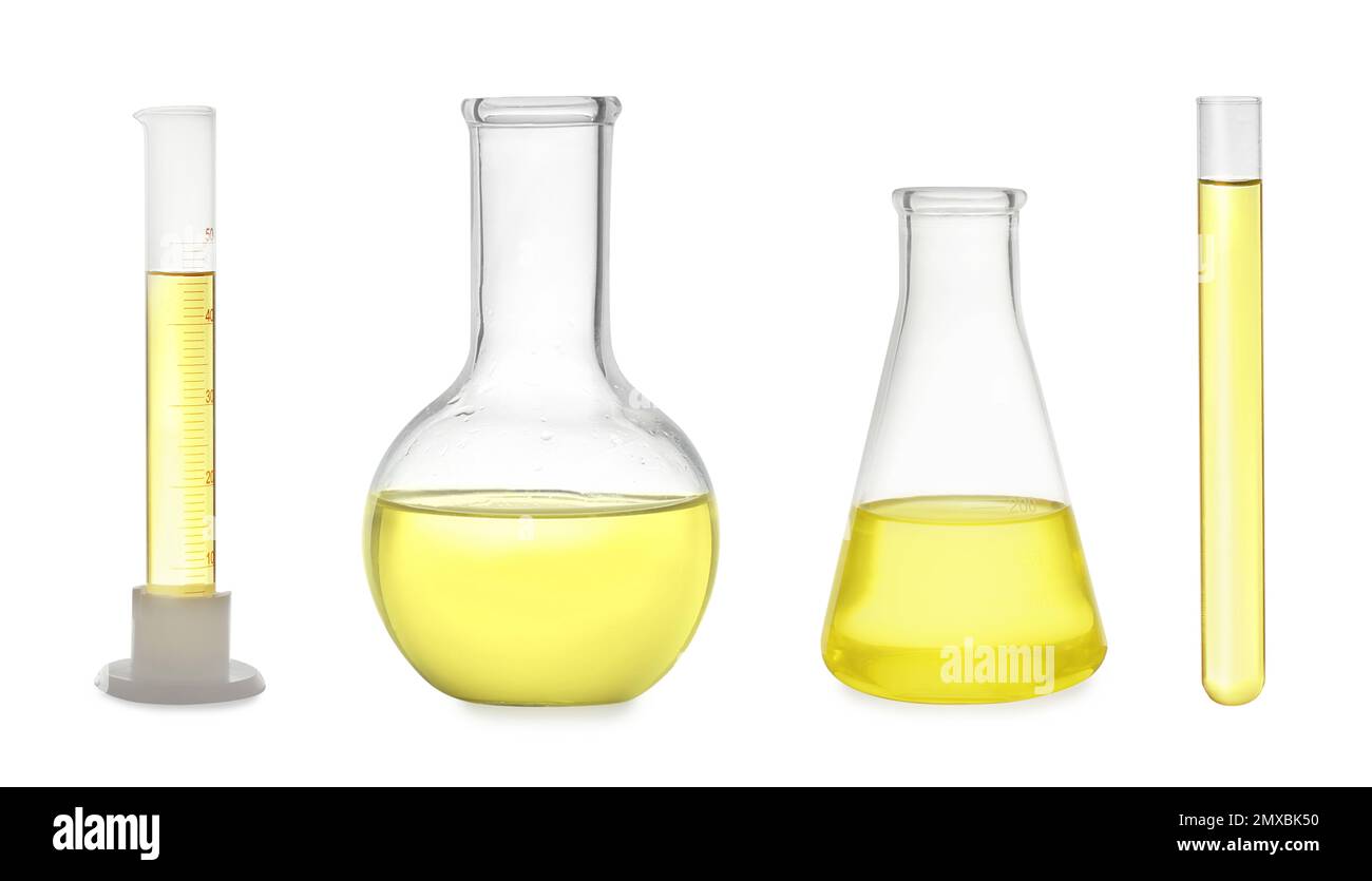 Set of laboratory glassware with yellow liquid on white background ...