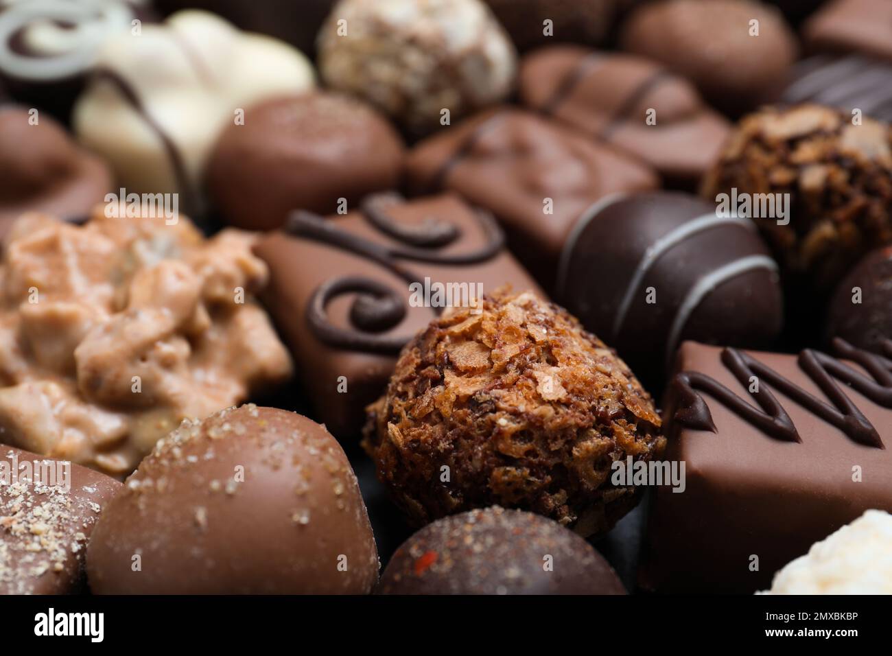 Different delicious chocolate candies as background, closeup Stock ...