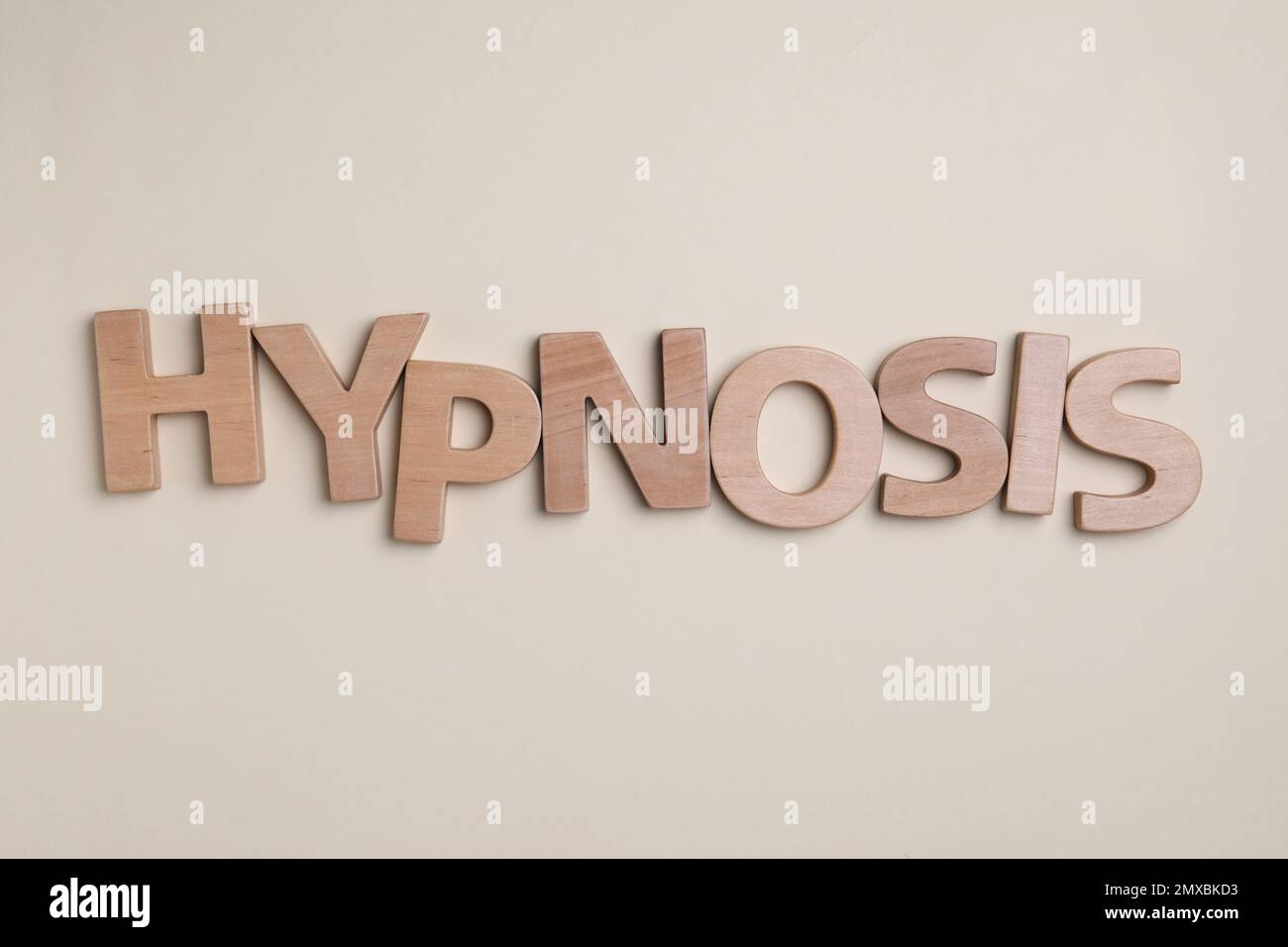 Word HYPNOSIS made with wooden letters on beige background, flat lay ...