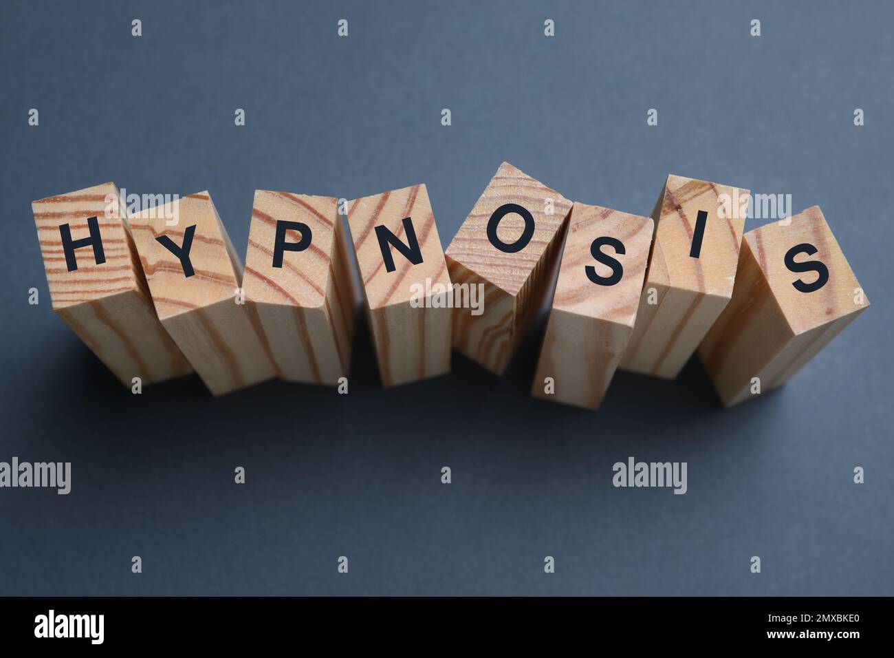 Wooden blocks with word HYPNOSIS on dark background, above view Stock ...
