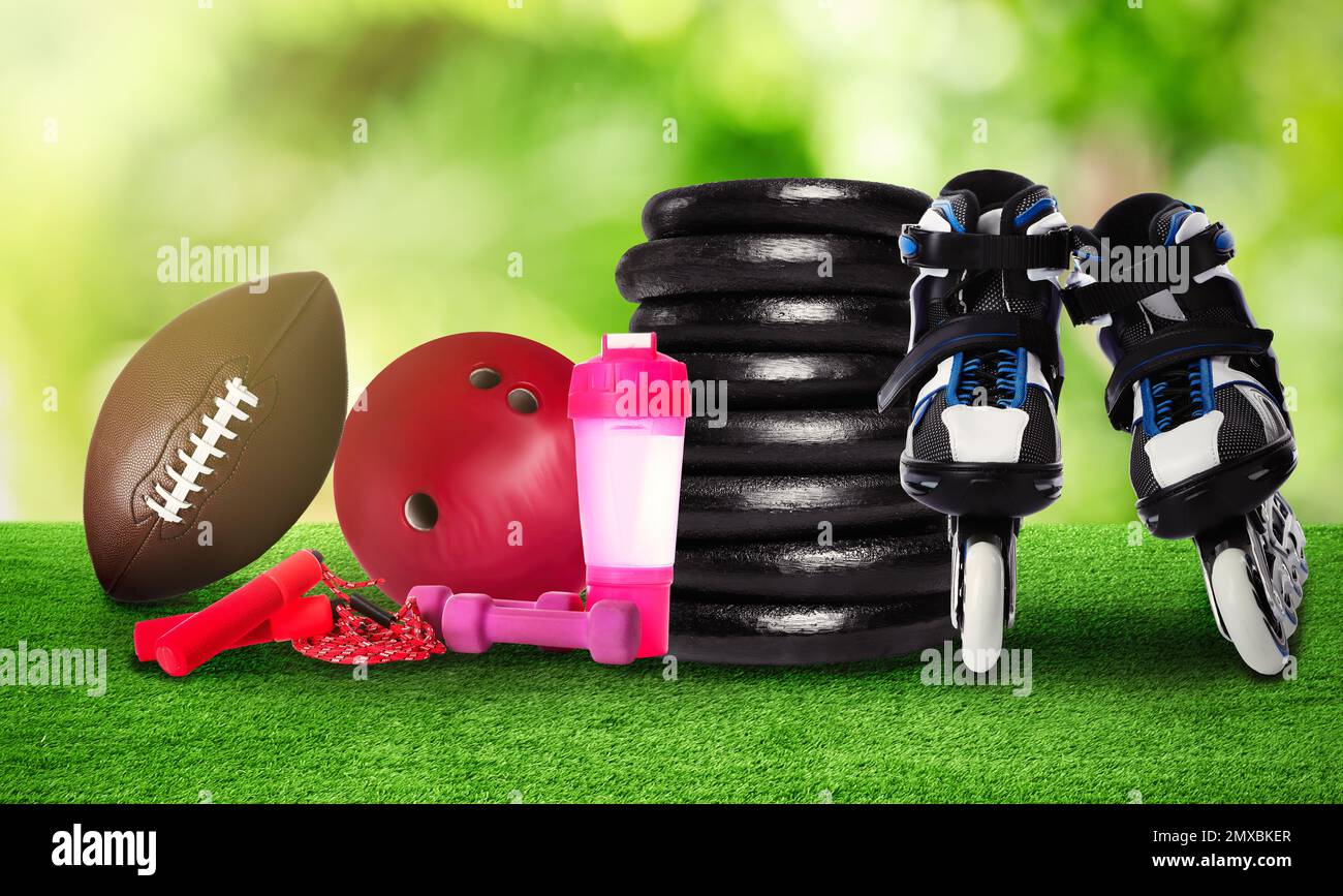 Set of different sport equipment on green grass Stock Photo - Alamy