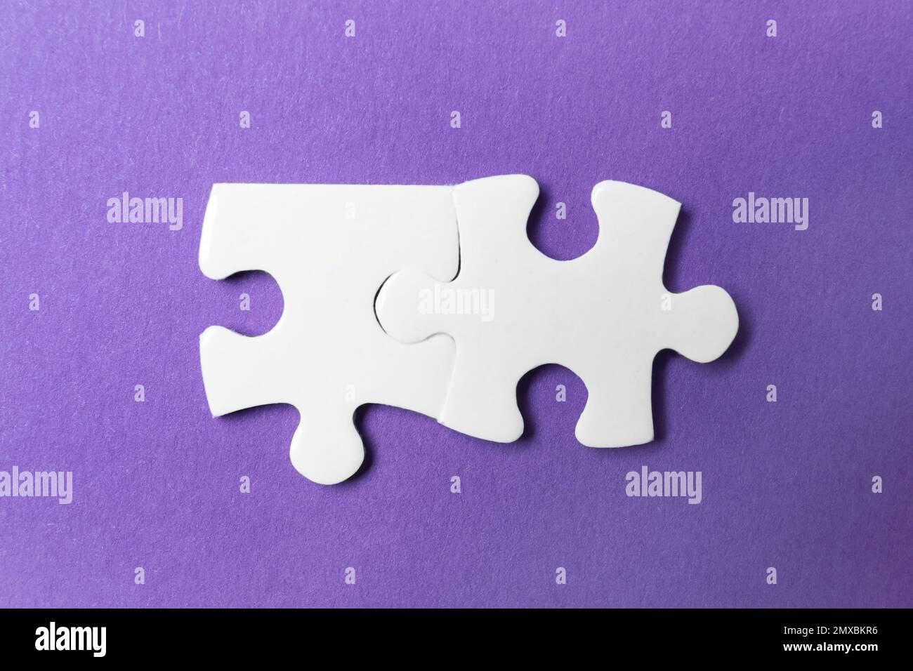Unfitting white puzzle pieces on purple background, flat lay Stock ...