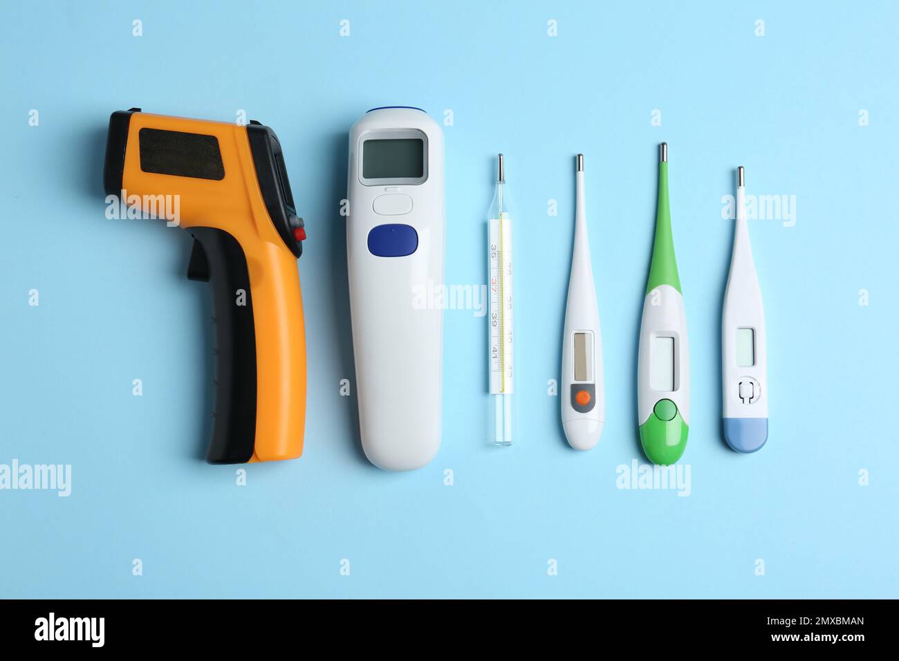 Different thermometers on light blue background, flat lay Stock Photo ...