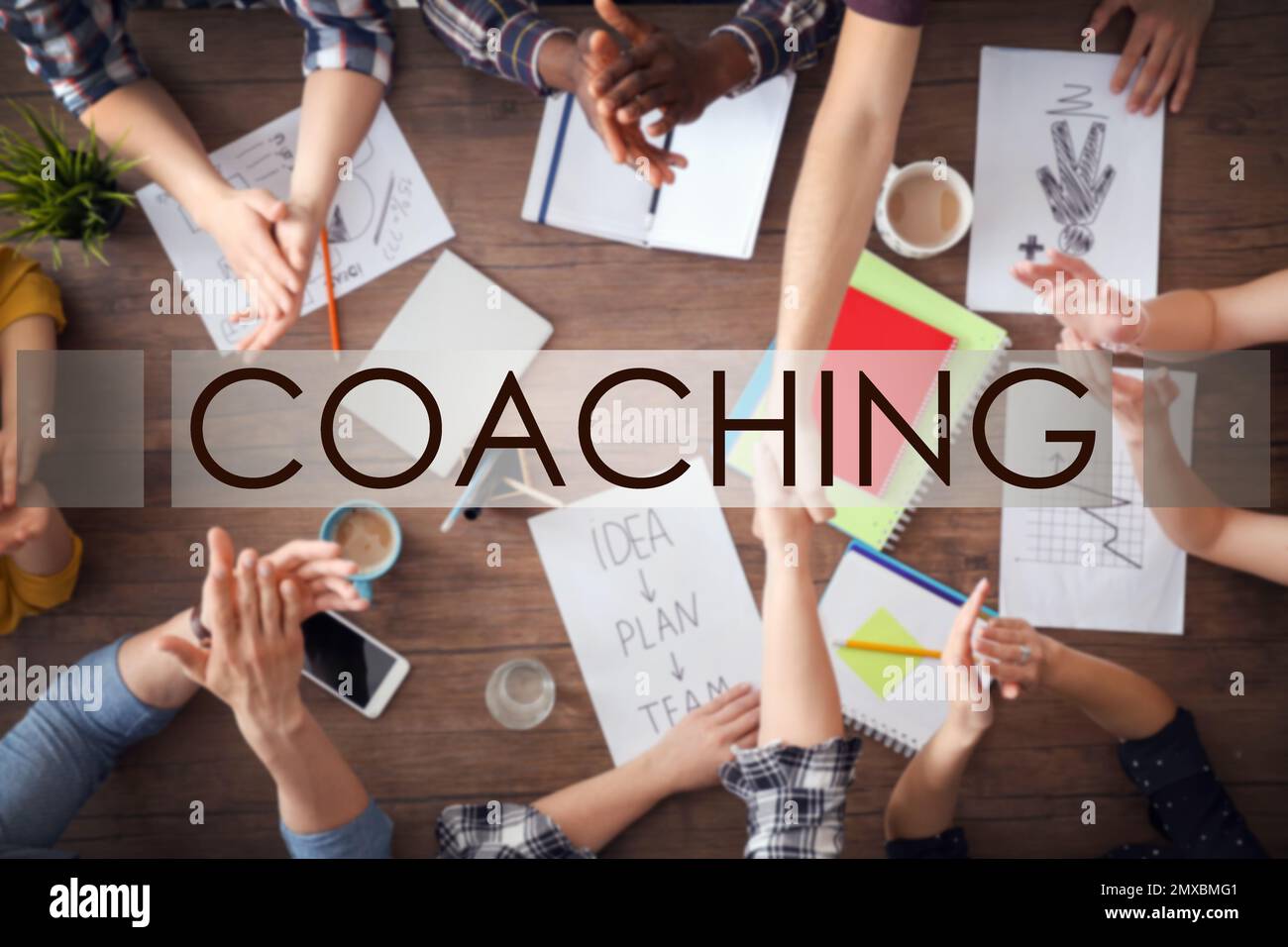 Adult learning. Word COACHING and people shaking hands at table, top ...