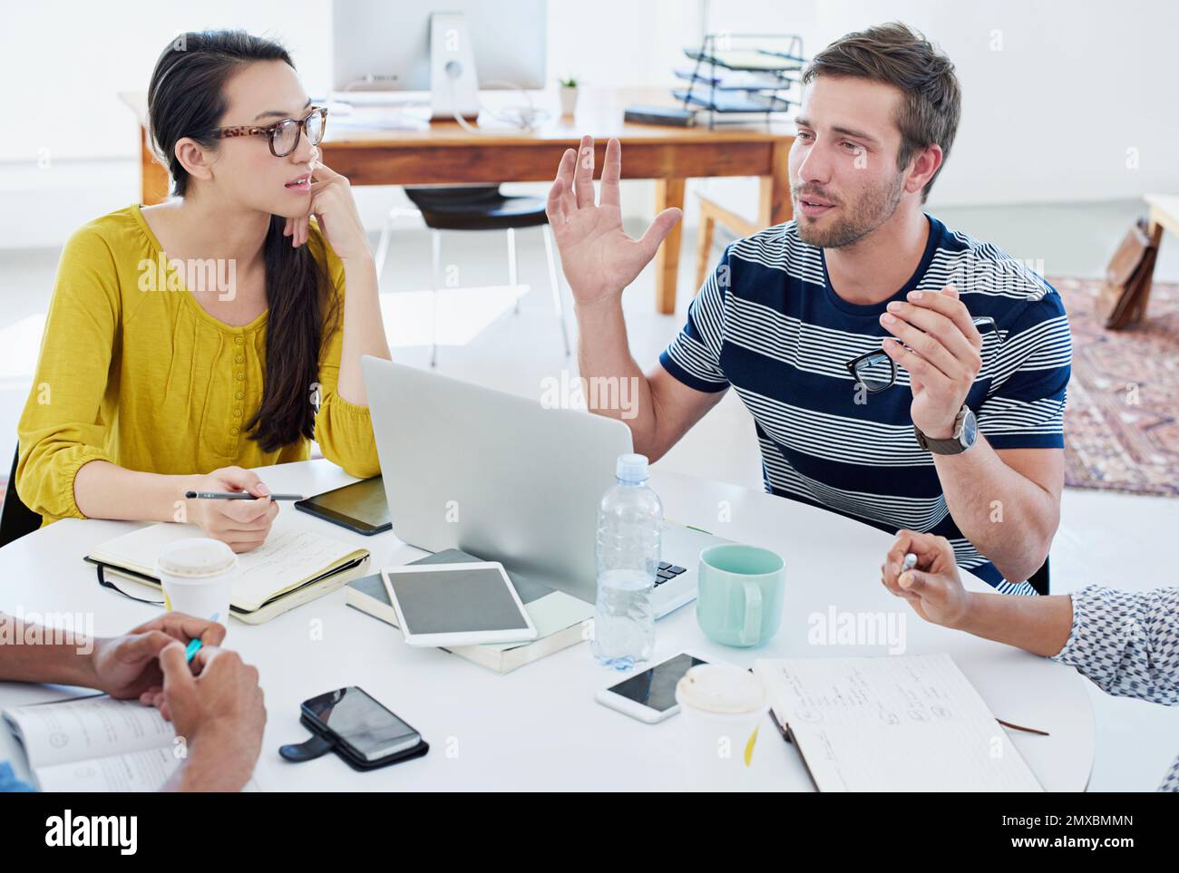 Multiracial co workers sharing ideas hi-res stock photography and ...