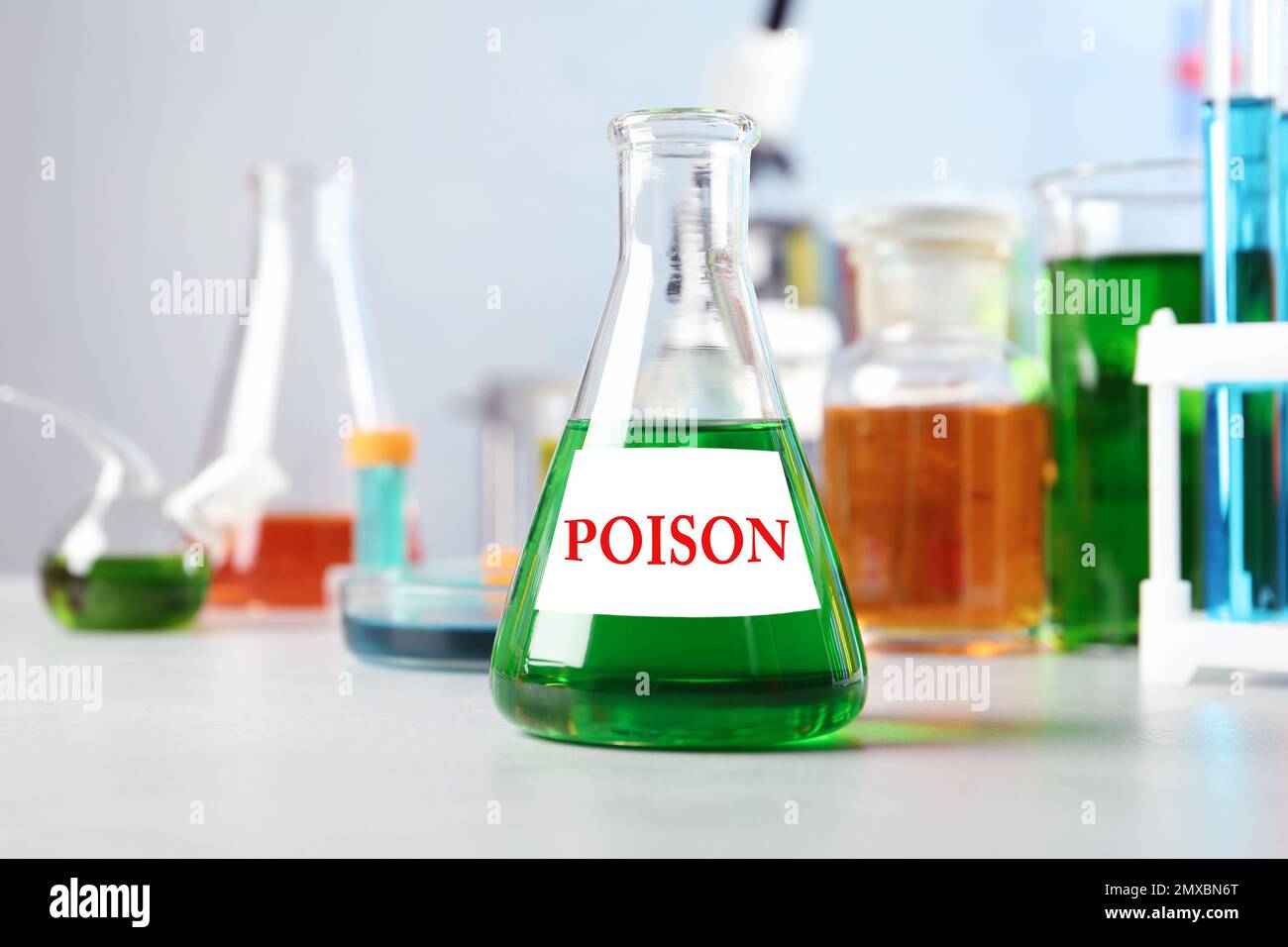 Flask with poison on table in laboratory Stock Photo - Alamy