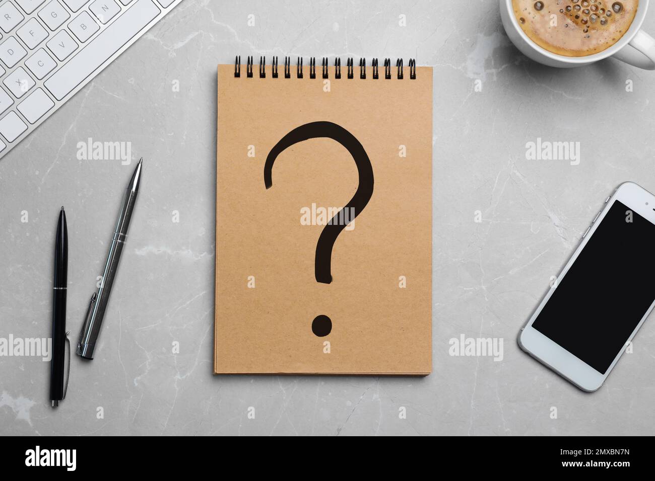 Flat lay composition of smartphone, pens and notebook with question ...