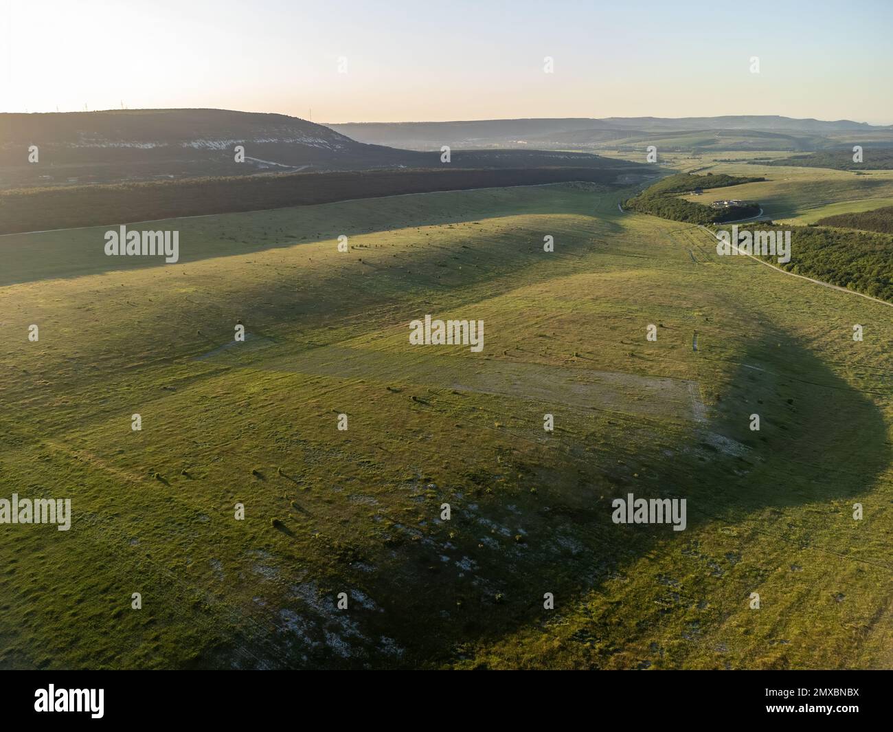 Aerial view on green wheat field, road and hills in countryside. Field ...