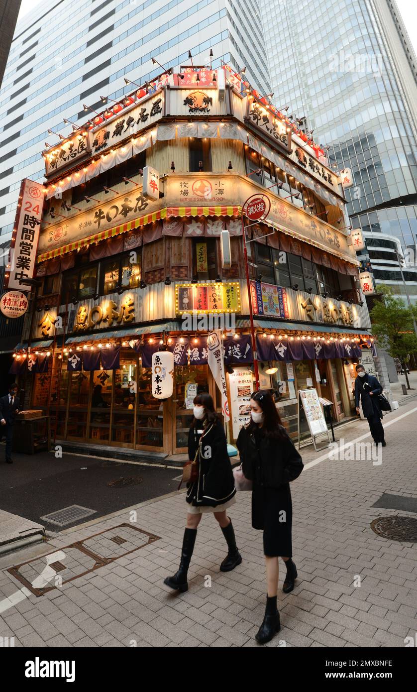 An old Japanese building ( Seafood restaurant ) with modern skyscrapers ...