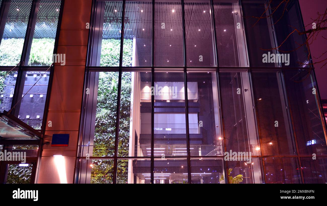 Night architecture, skyscraper with glass facade. Modern building in ...